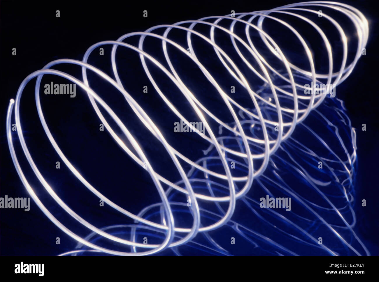 Coiled metal spring energy industry power connection Stock Photo - Alamy