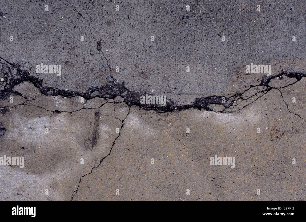Pothole in cracked cement pavement sidewalk. Urban decay and neglect in ...