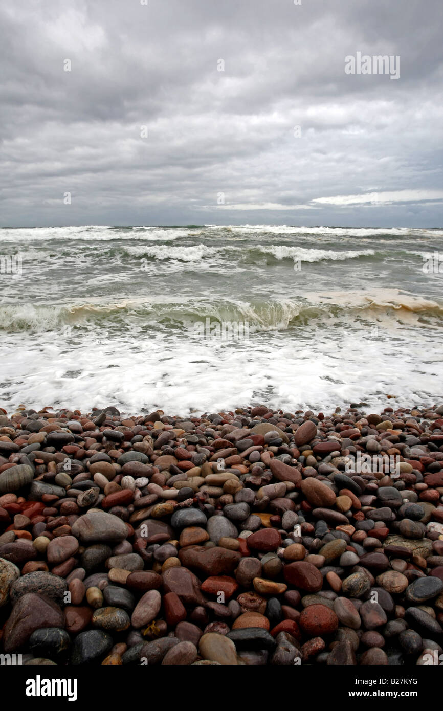 Shingle beach with pebbles and stones, stormy waves and grey sky Stock ...