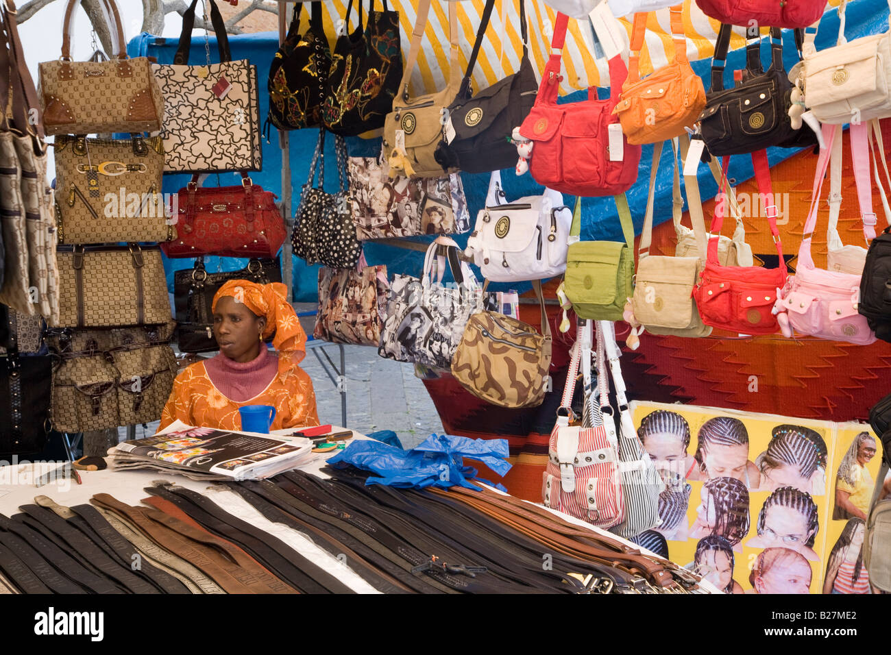 African woman selling handbags and leather belts on market stall Teror ...