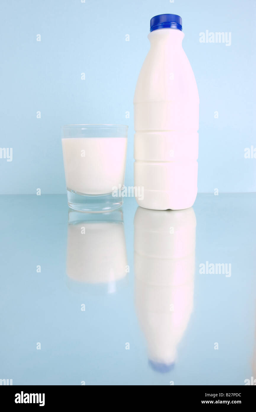 Full cream milk isolated against a blue background Stock Photo - Alamy