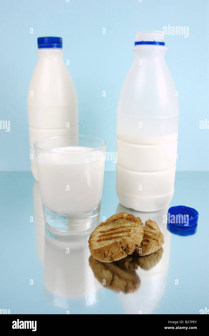 Milk and cookies isolated against a blue background Stock Photo - Alamy