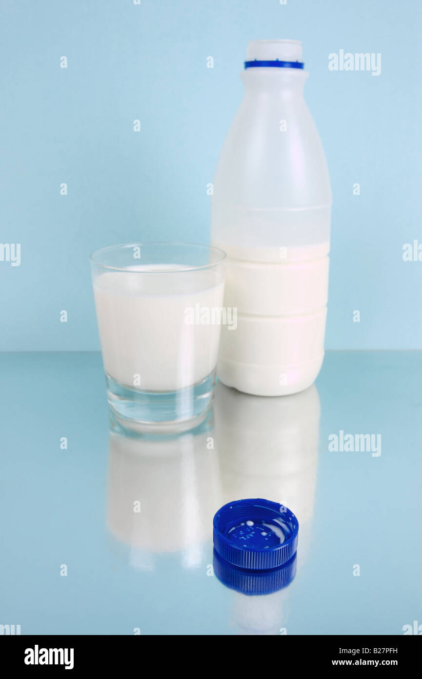 Full cream milk isolated against a blue background Stock Photo - Alamy