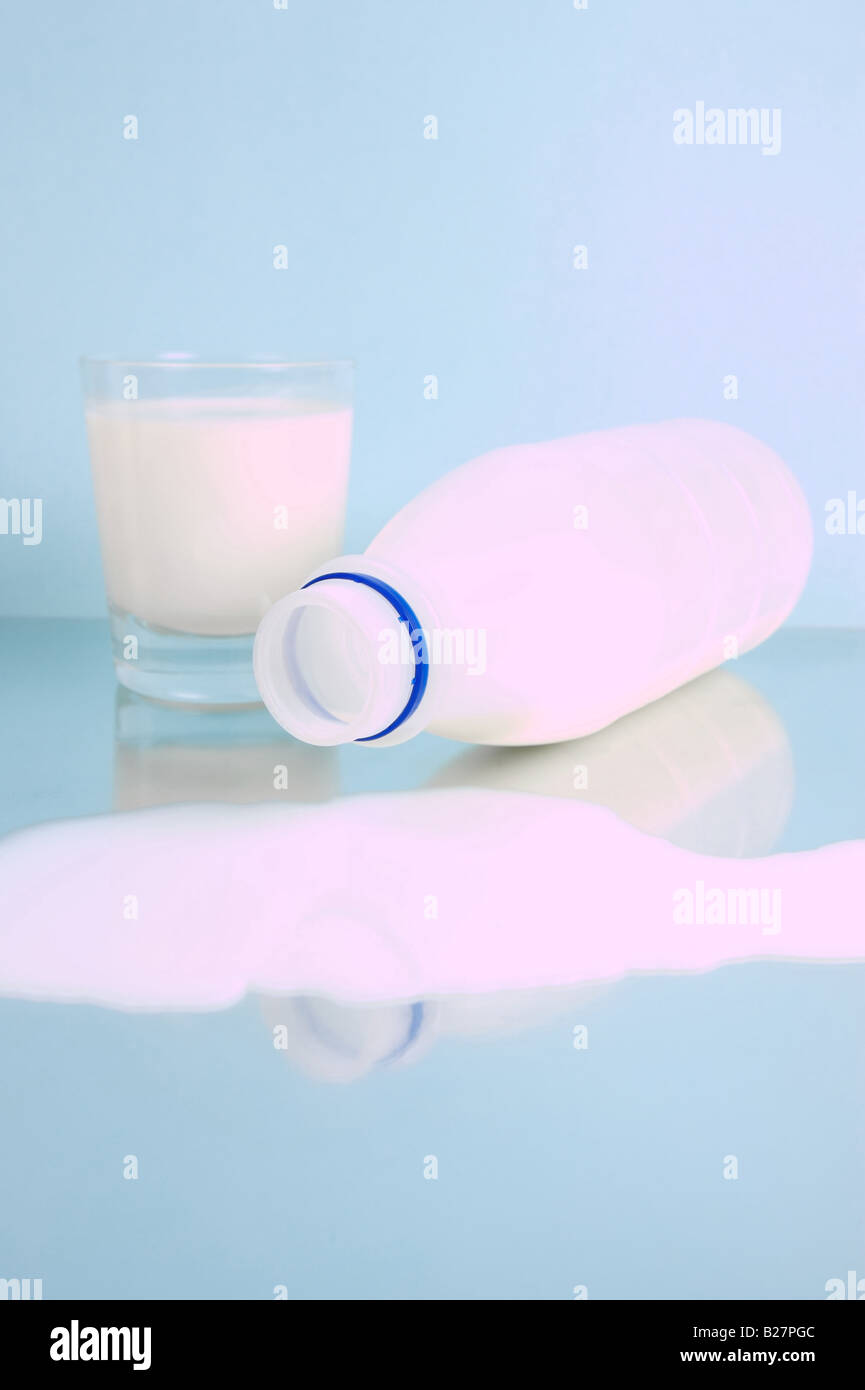 Spilt full cream milk isolated against a blue background Stock Photo ...