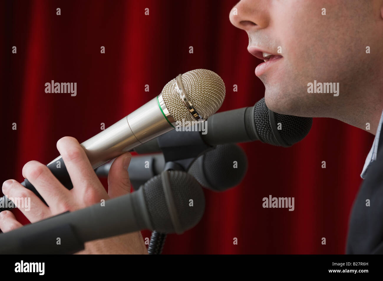 Man speaking into microphone Stock Photo - Alamy
