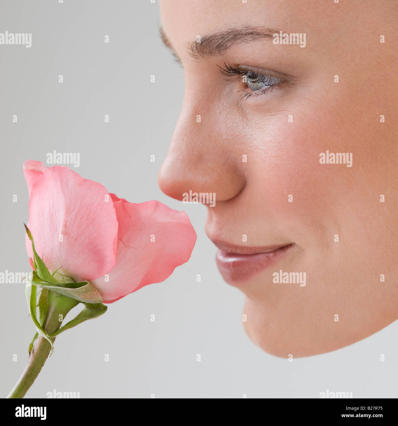 Woman smelling flower Stock Photo - Alamy