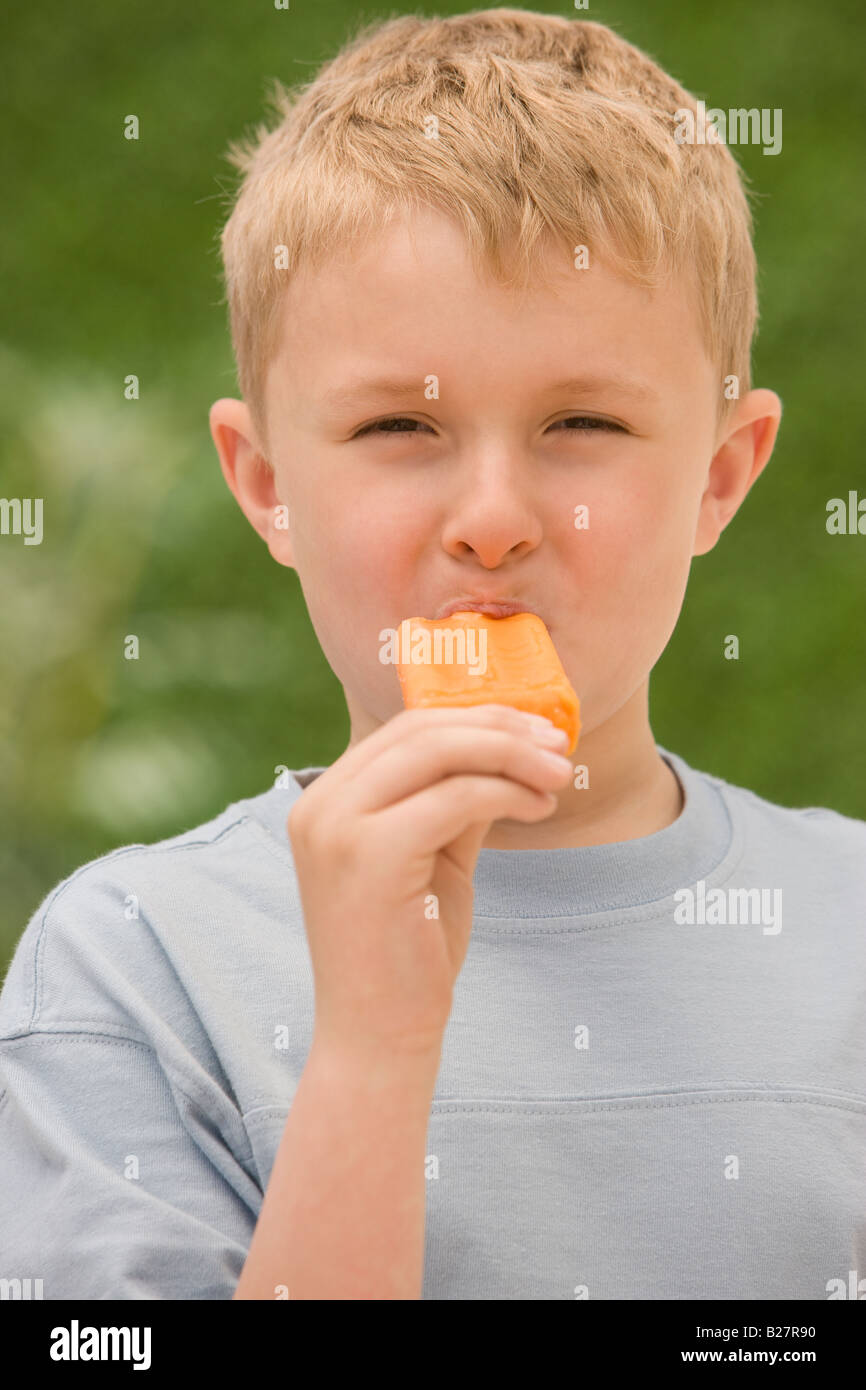 Boy eating ice pop Stock Photo - Alamy