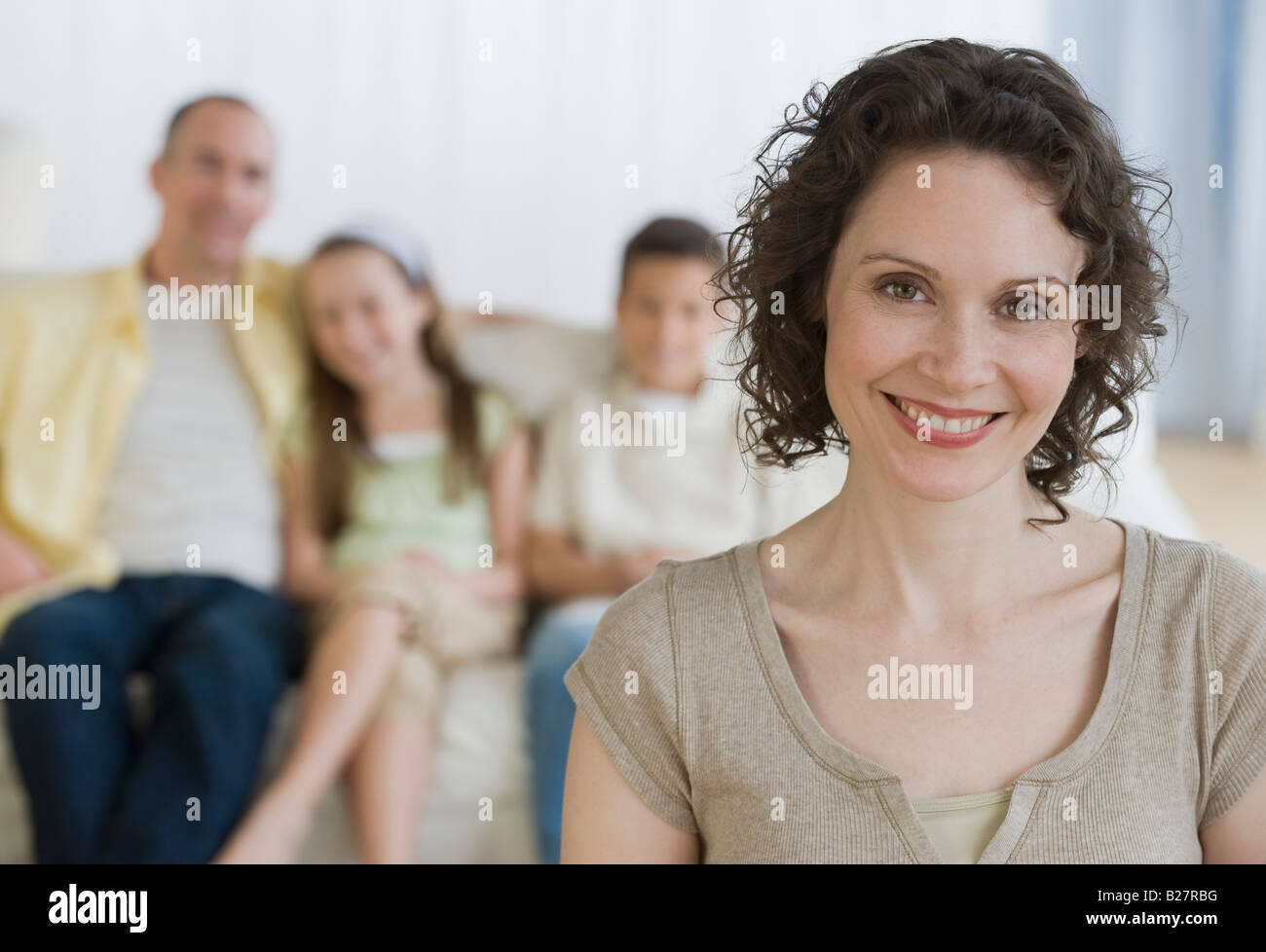 Mother with family in background Stock Photo - Alamy