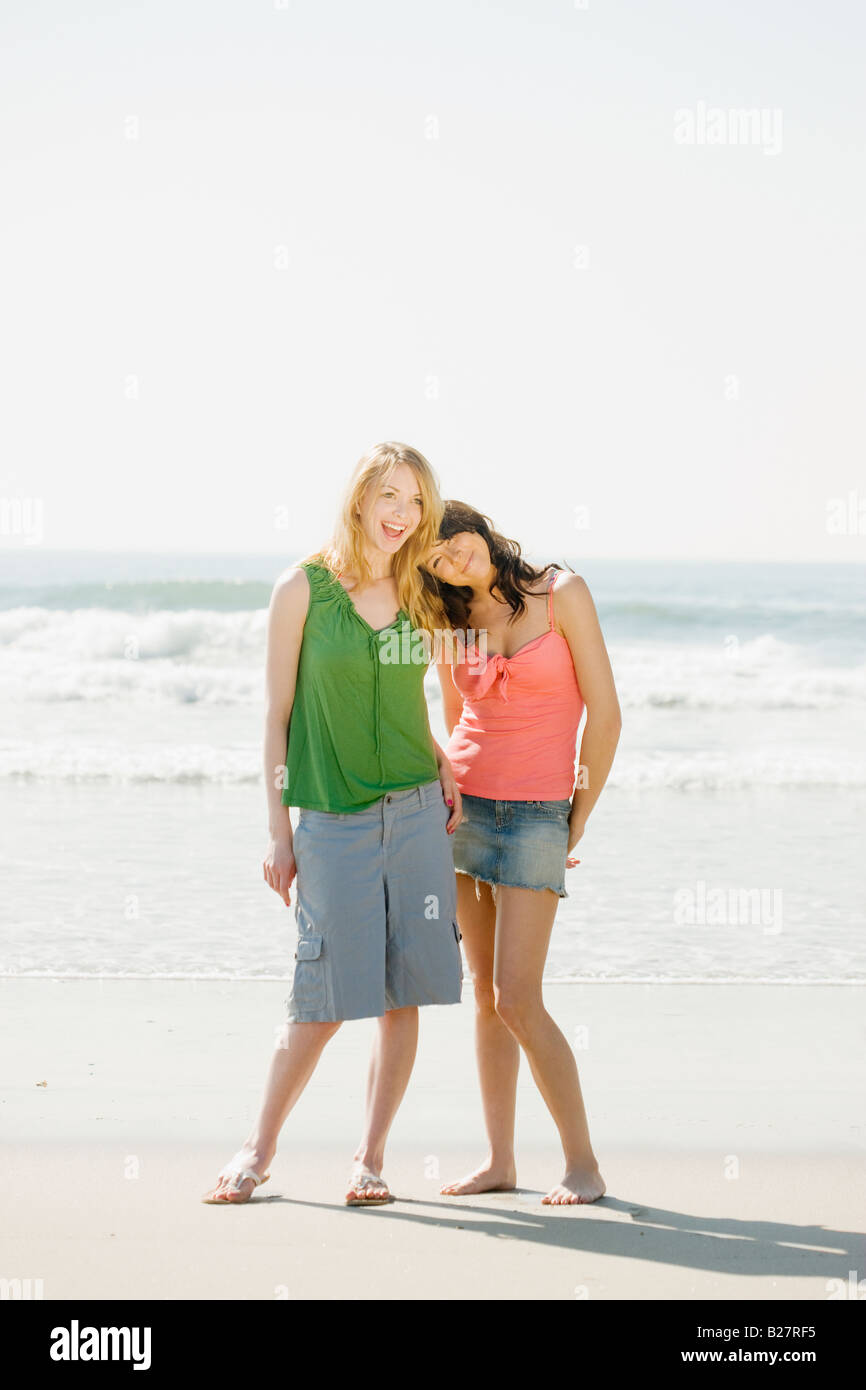 Two women standing on beach Stock Photo - Alamy