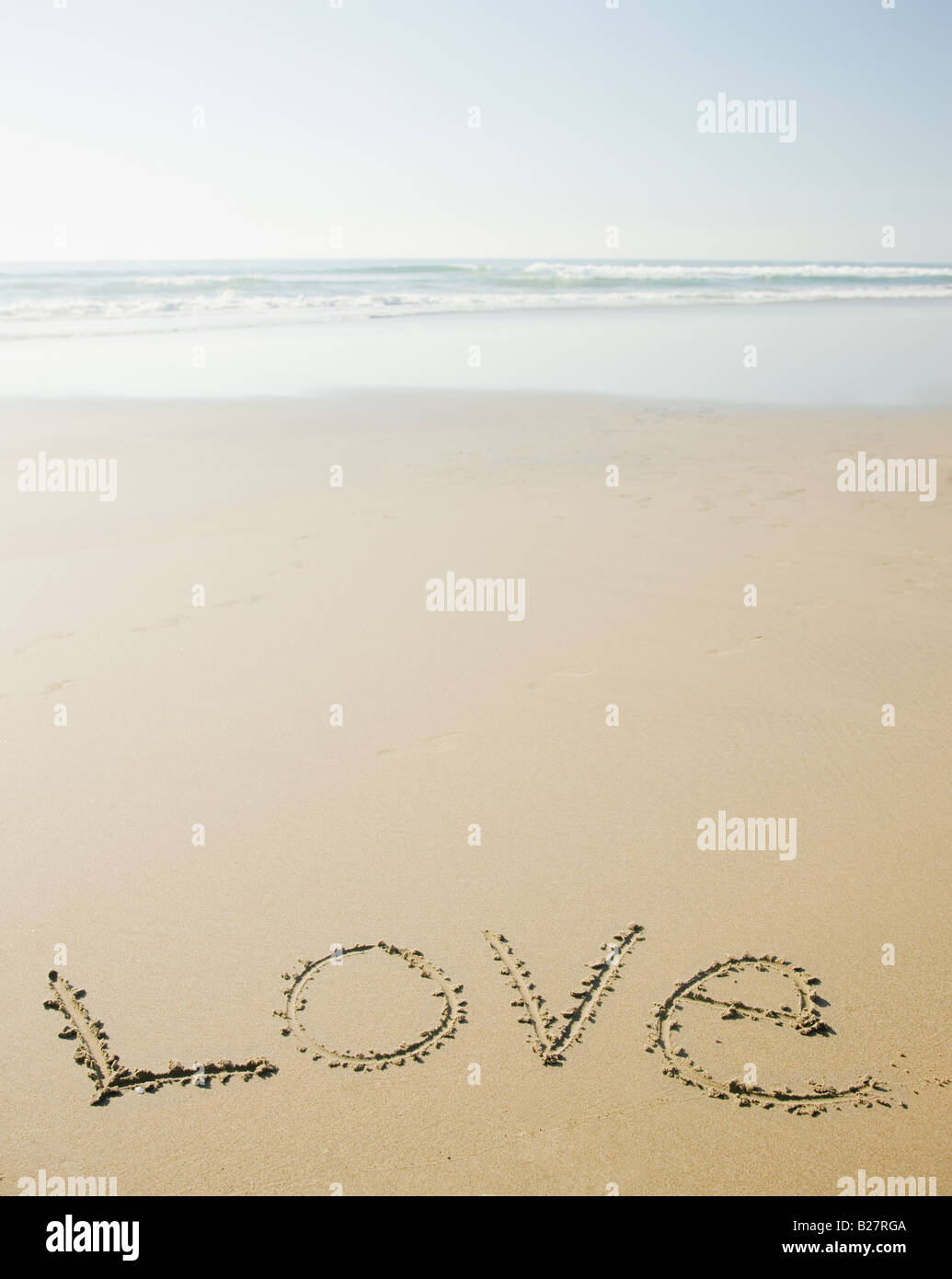 Love written in sand Stock Photo - Alamy