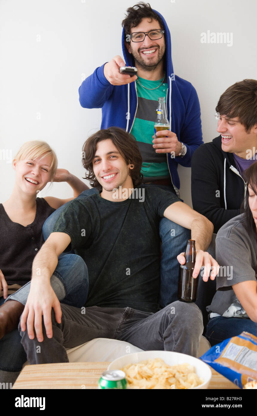 Group of friends watching television Stock Photo - Alamy