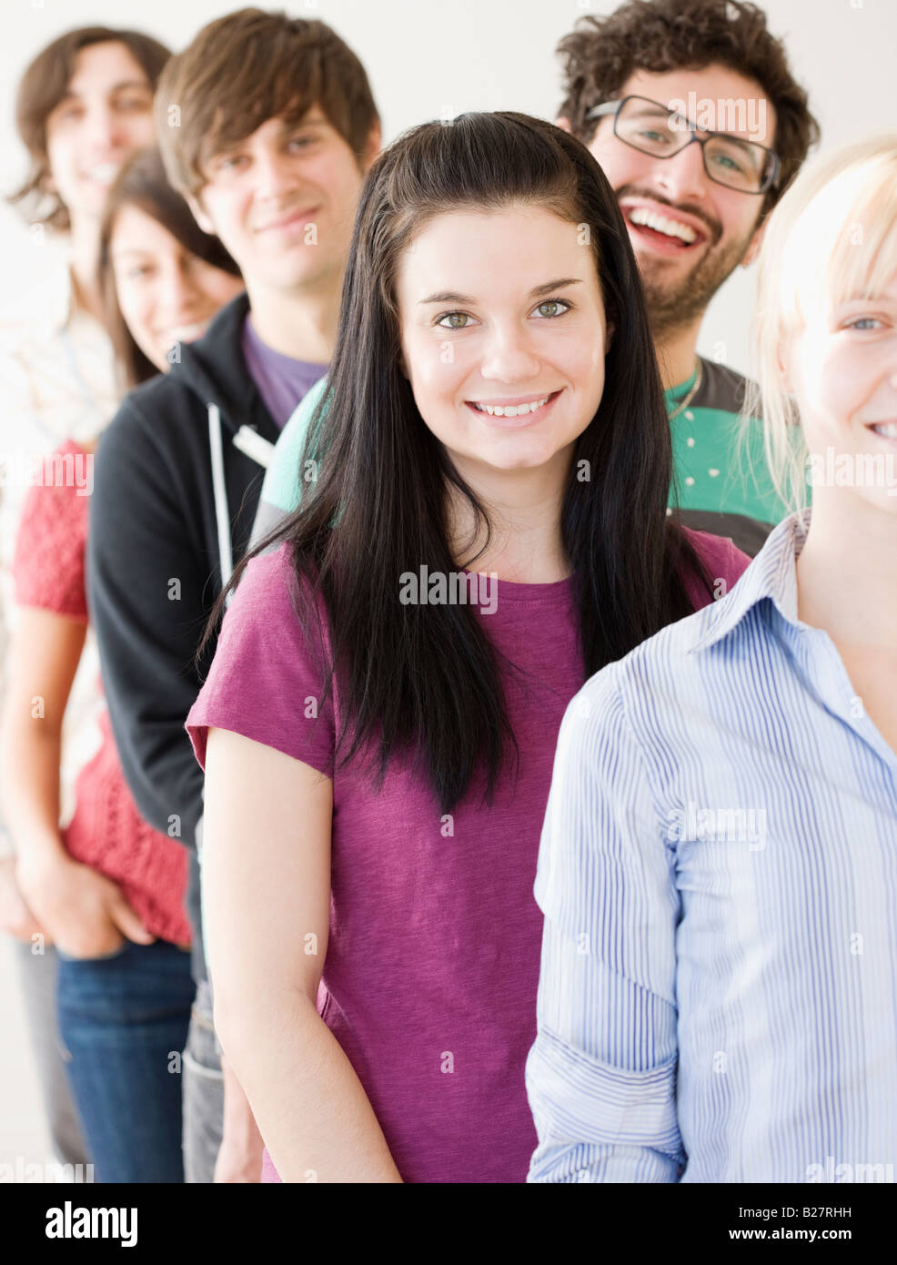 Group of friends standing in row Stock Photo - Alamy