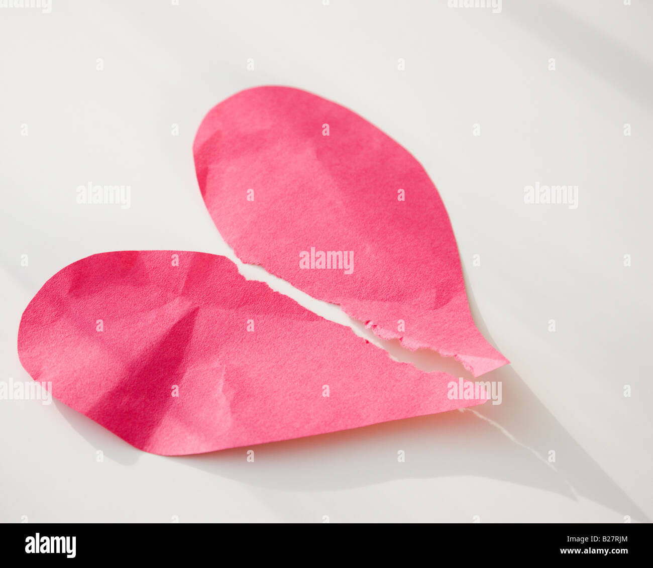Paper heart ripped in half Stock Photo - Alamy