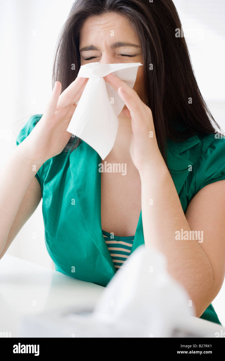 Woman blowing nose Stock Photo - Alamy