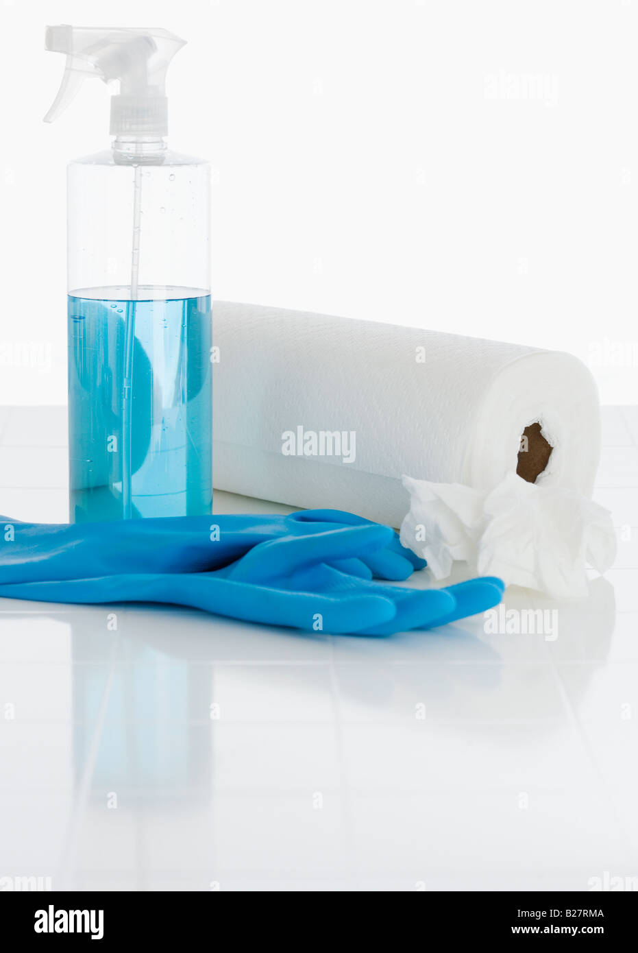 Rubber gloves and cleaning solution next to paper towels Stock Photo ...