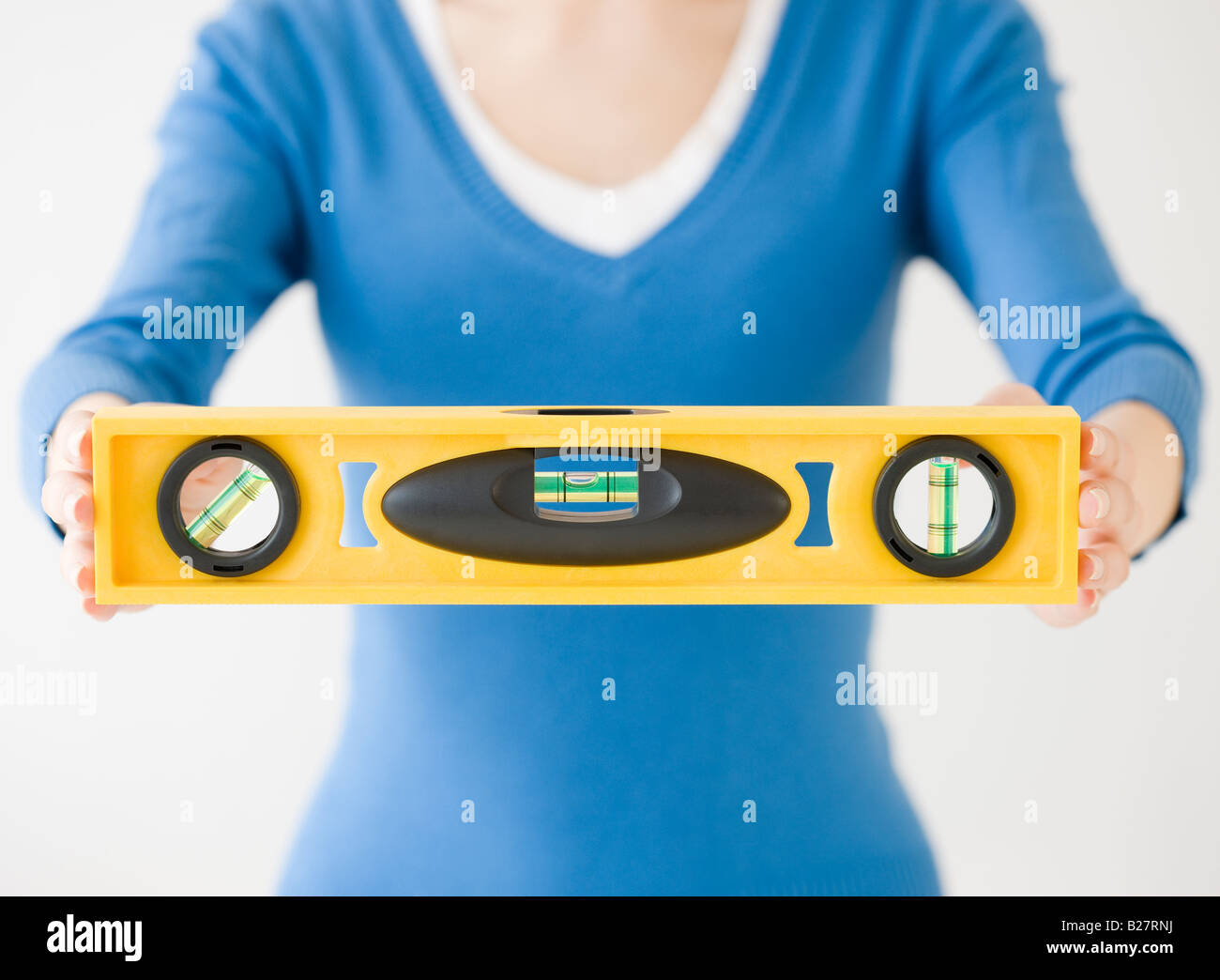 Woman holding level tool Stock Photo - Alamy