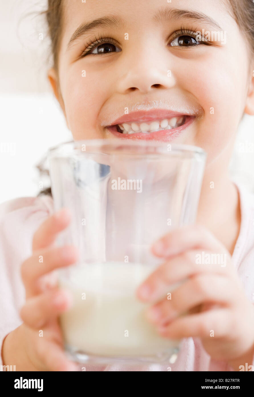 Hispanic girl holding glass of milk Stock Photo - Alamy