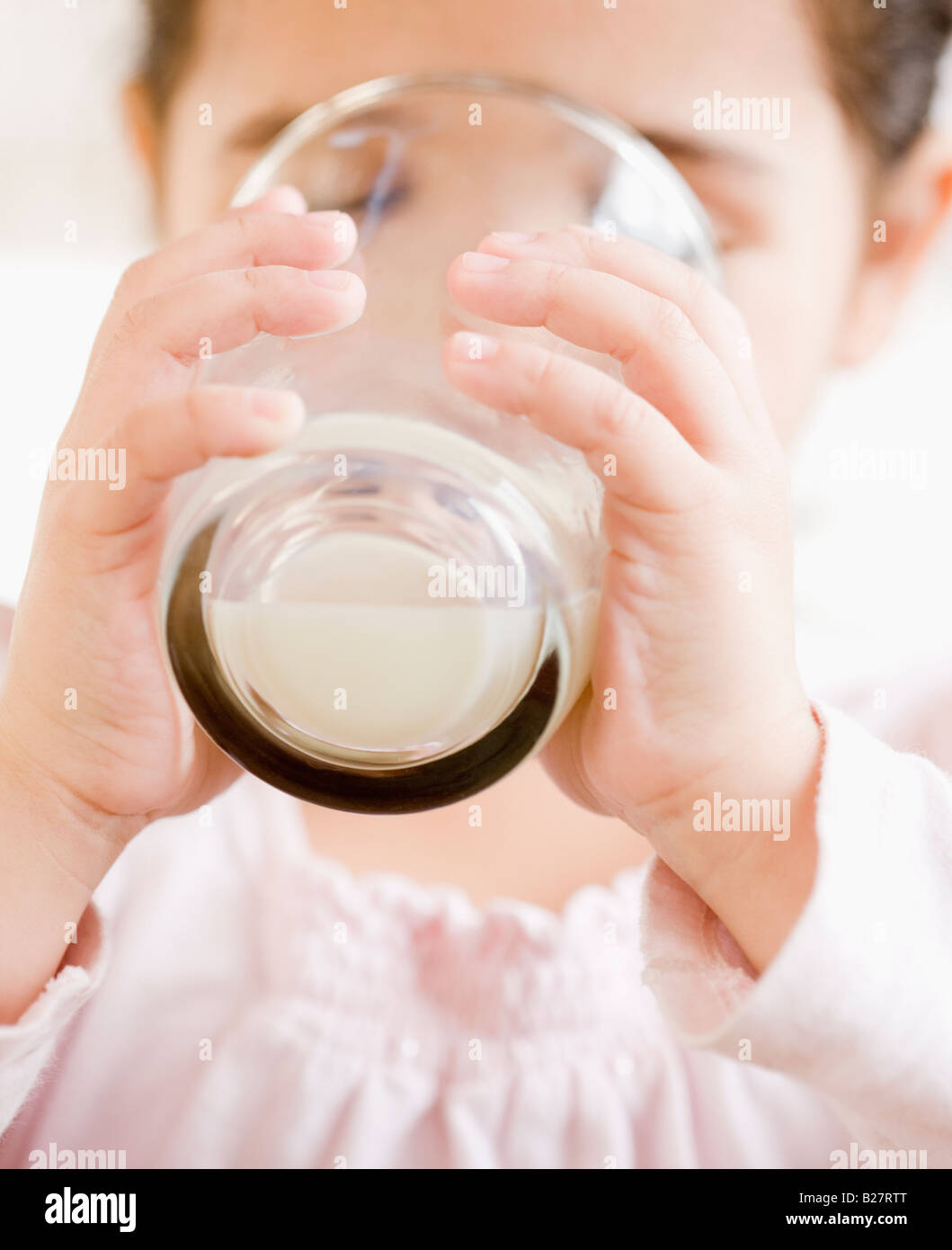 Hispanic girl drinking glass of milk Stock Photo - Alamy