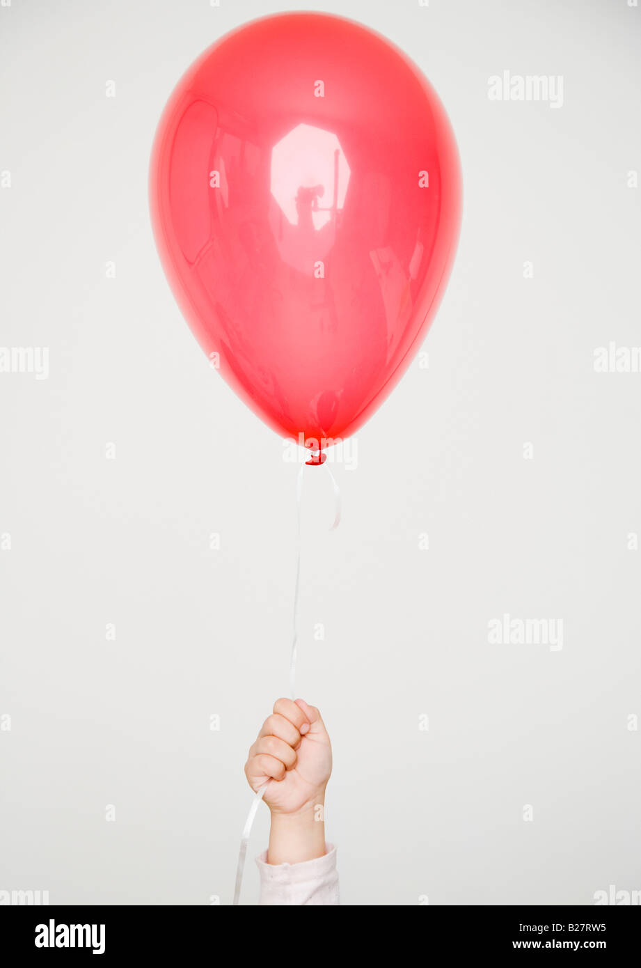 Child holding red balloon Stock Photo - Alamy