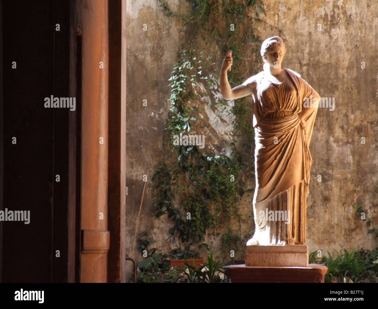 one roman female statue in a courtyard in a villa in rome italy Stock ...