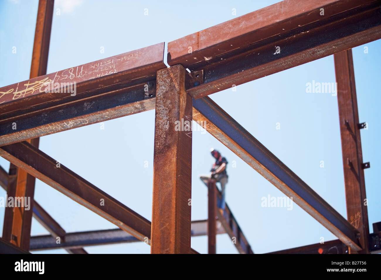Construction worker on steel beam at construction site Stock Photo - Alamy