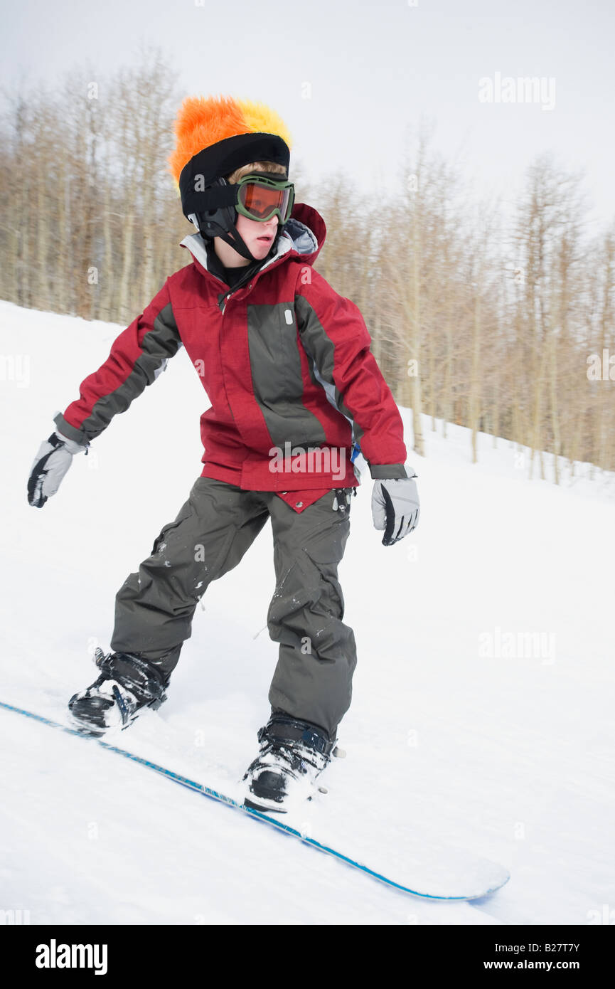 Boy snowboarding downhill Stock Photo - Alamy