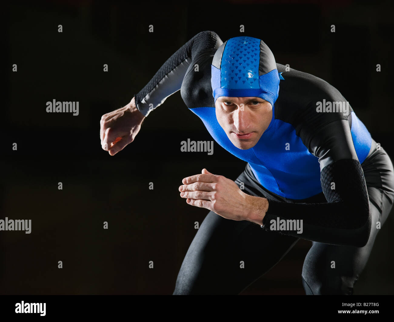 Male speed skater in ready position Stock Photo - Alamy