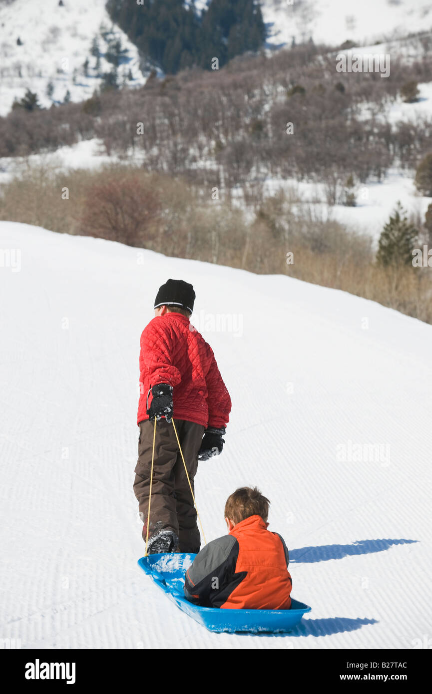 Boys pulling sled hi-res stock photography and images - Alamy