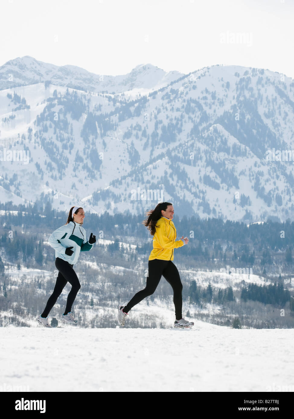 Women running in snow Stock Photo - Alamy