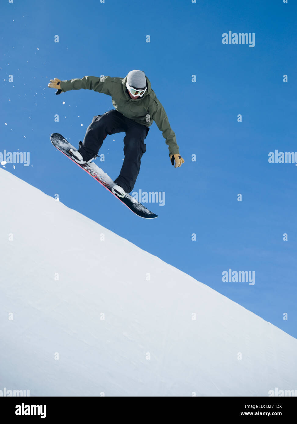 Man on snowboard in air Stock Photo - Alamy