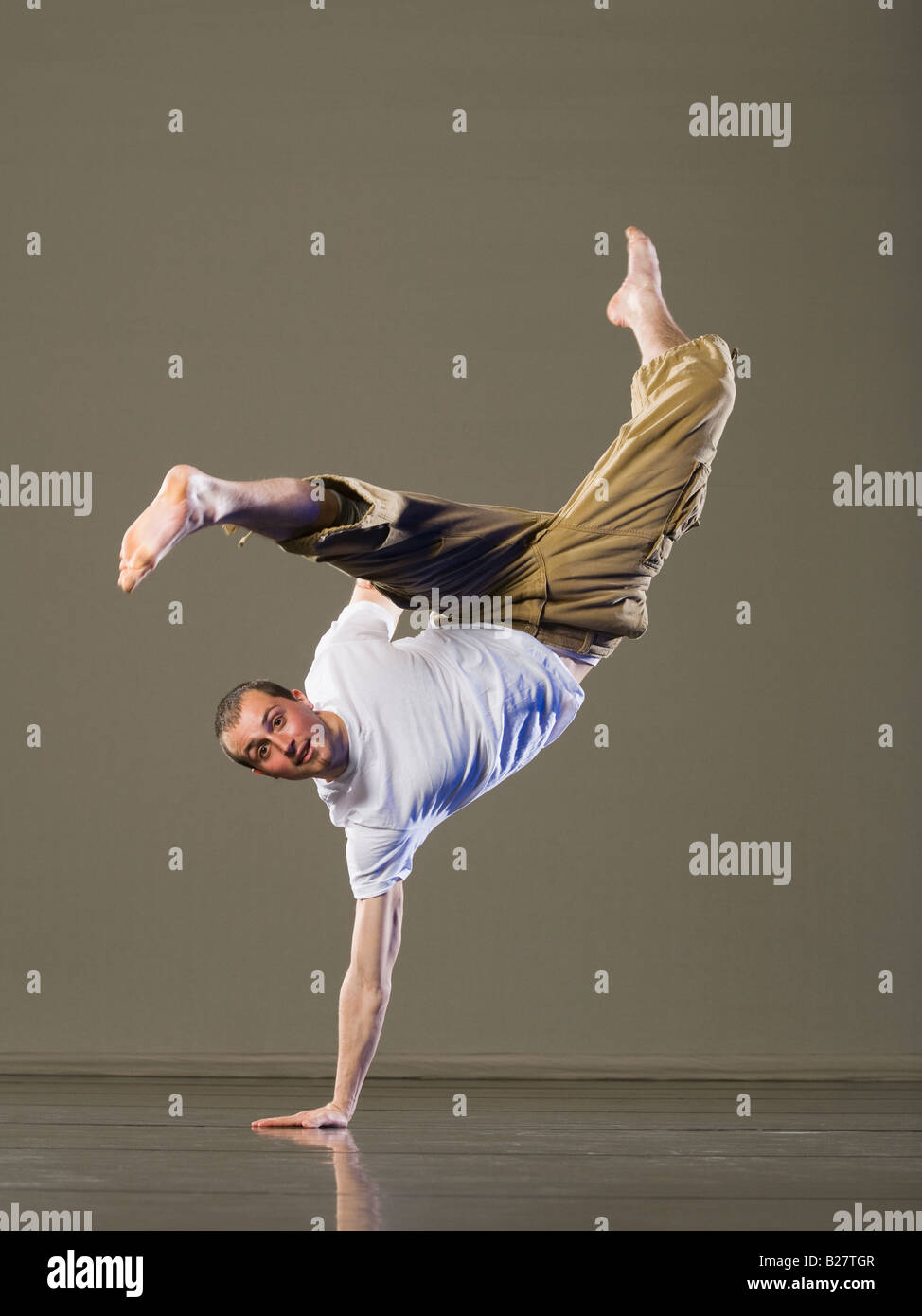 Man balancing on one hand Stock Photo - Alamy