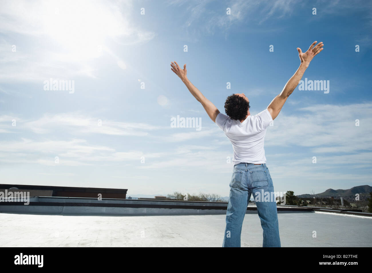 Man with arms raised Stock Photo - Alamy