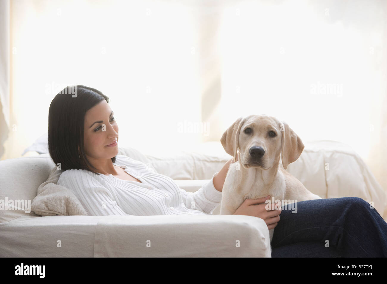 Dog on woman’s lap Stock Photo - Alamy