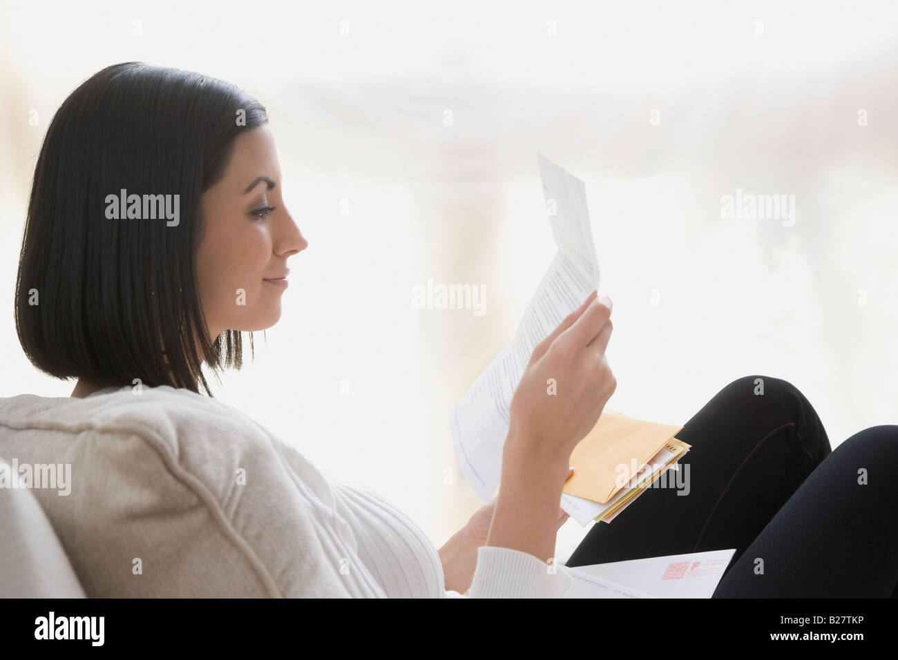 Woman reading mail Stock Photo - Alamy