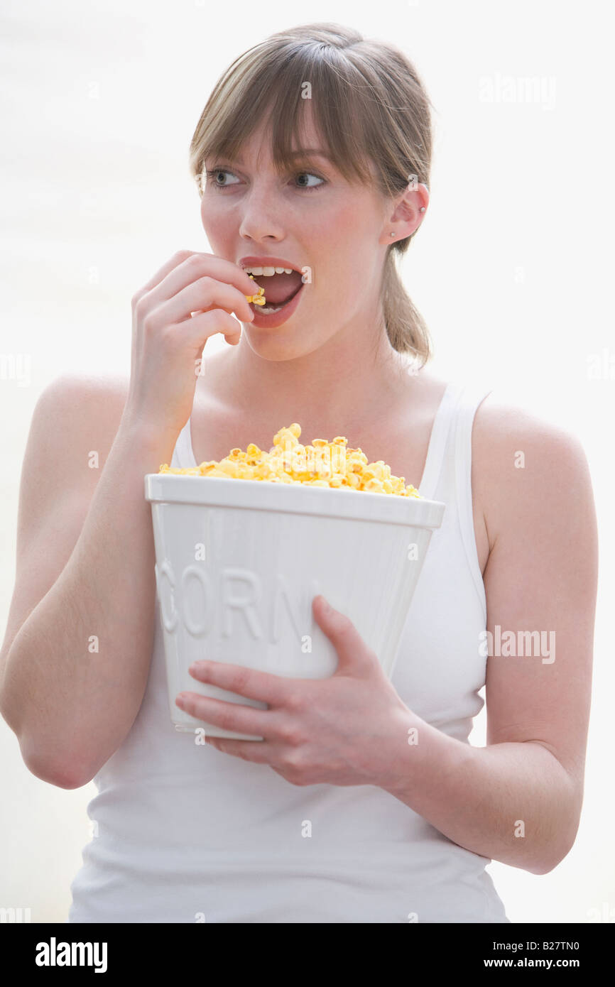Woman eating popcorn Stock Photo - Alamy