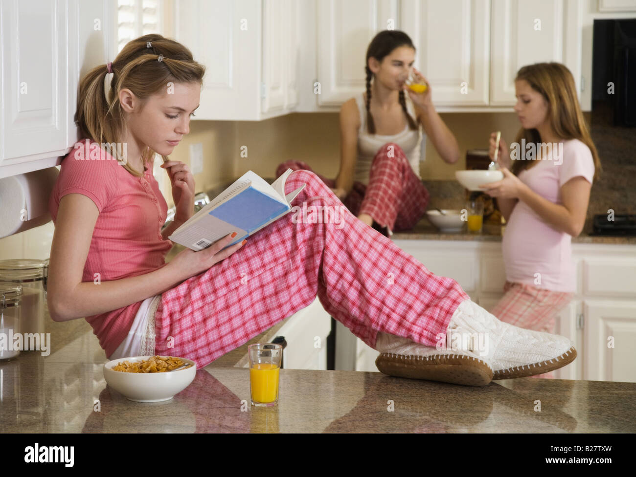 Teenaged girls eating breakfast Stock Photo - Alamy
