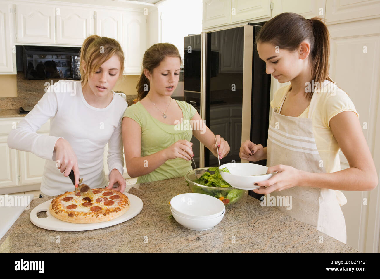 Hispanic girl eating pizza hi-res stock photography and images - Alamy