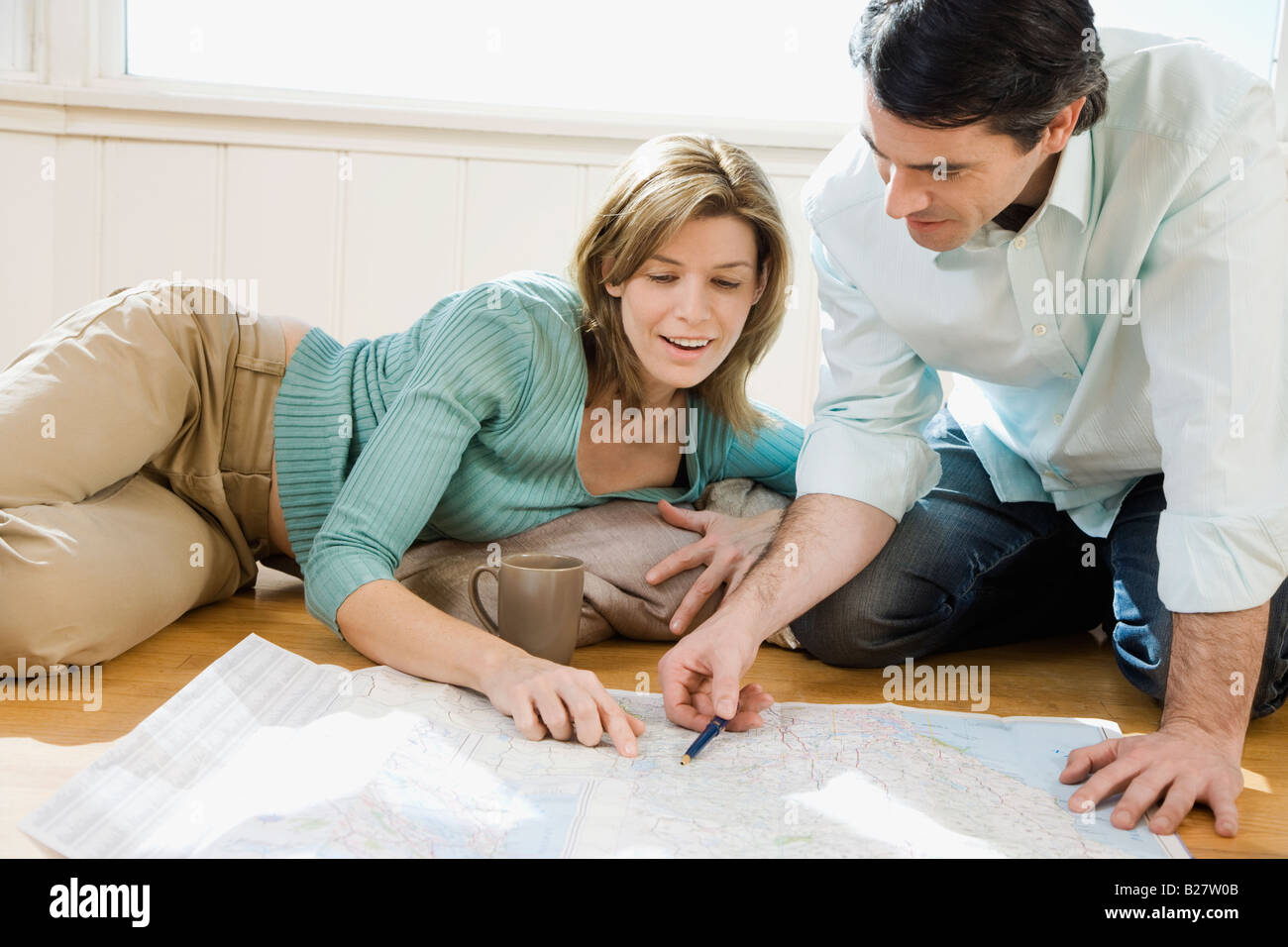 Couple looking at blueprints Stock Photo - Alamy