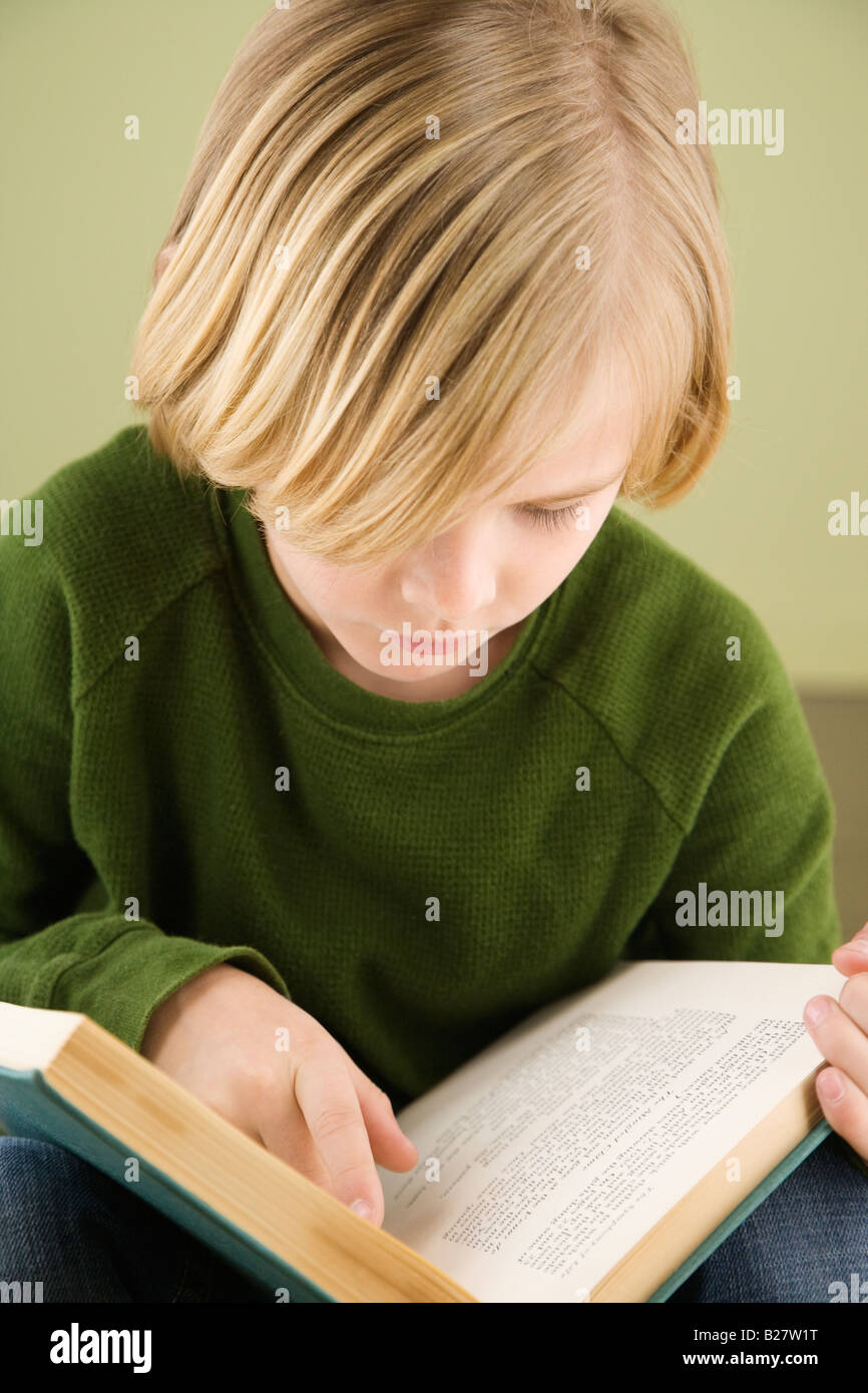 Boy reading book Stock Photo - Alamy