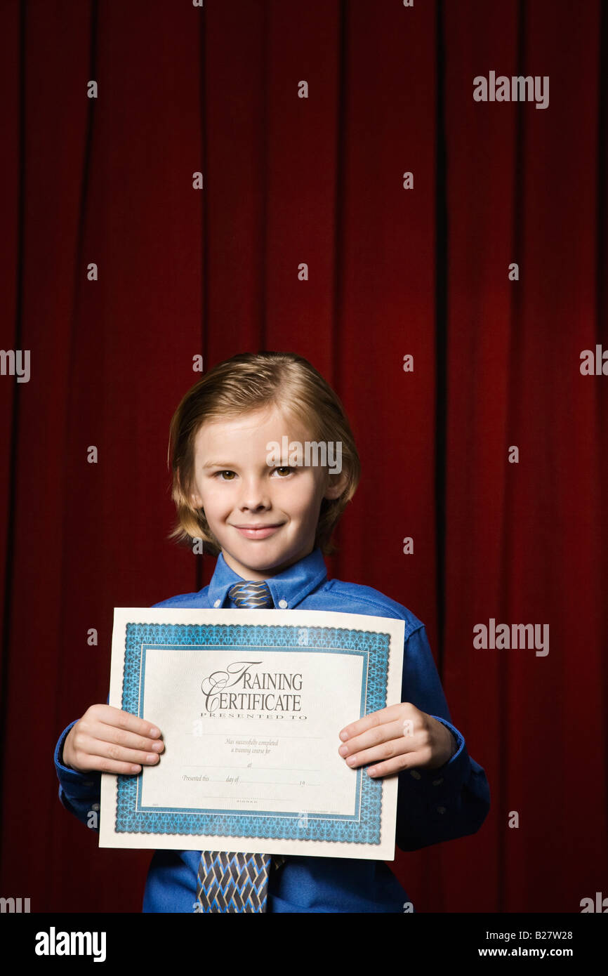 Boy holding certificate on stage Stock Photo - Alamy