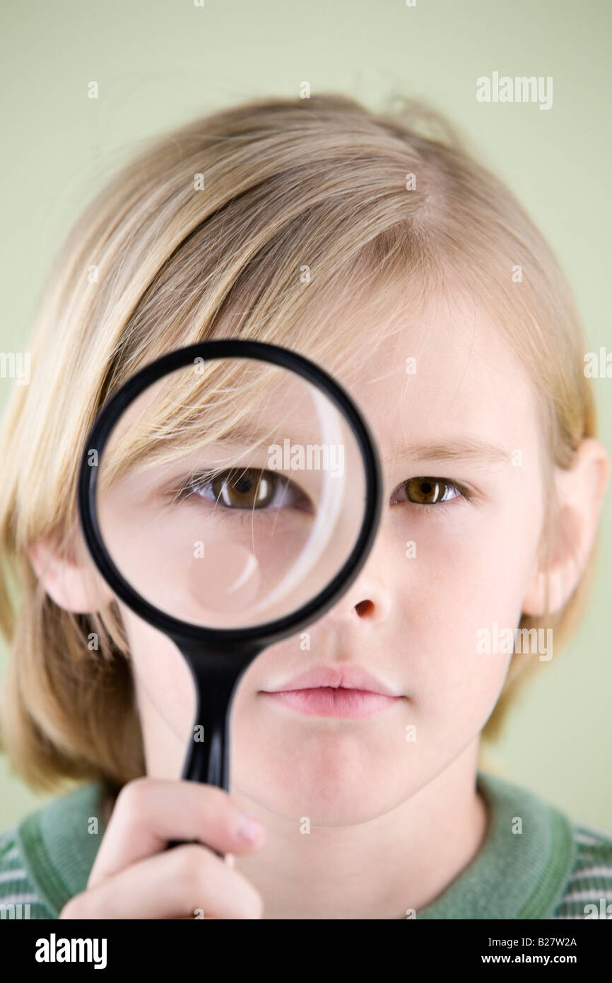 Person looking though magnifying glass hi-res stock photography and ...
