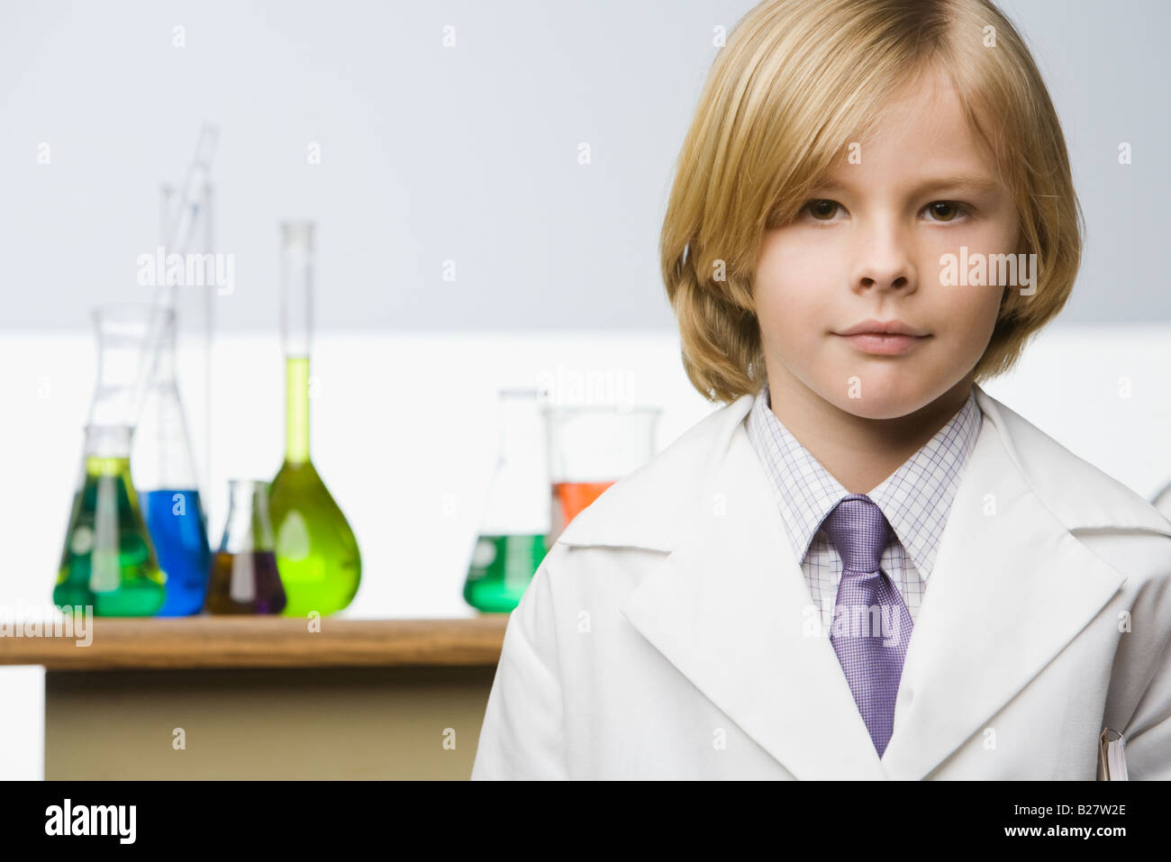 Boy in front of science beakers Stock Photo - Alamy