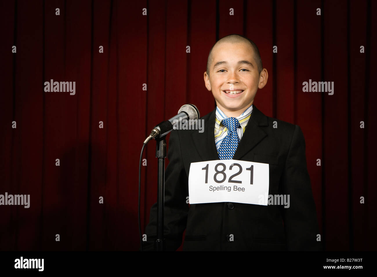 Boy wearing number on stage Stock Photo - Alamy