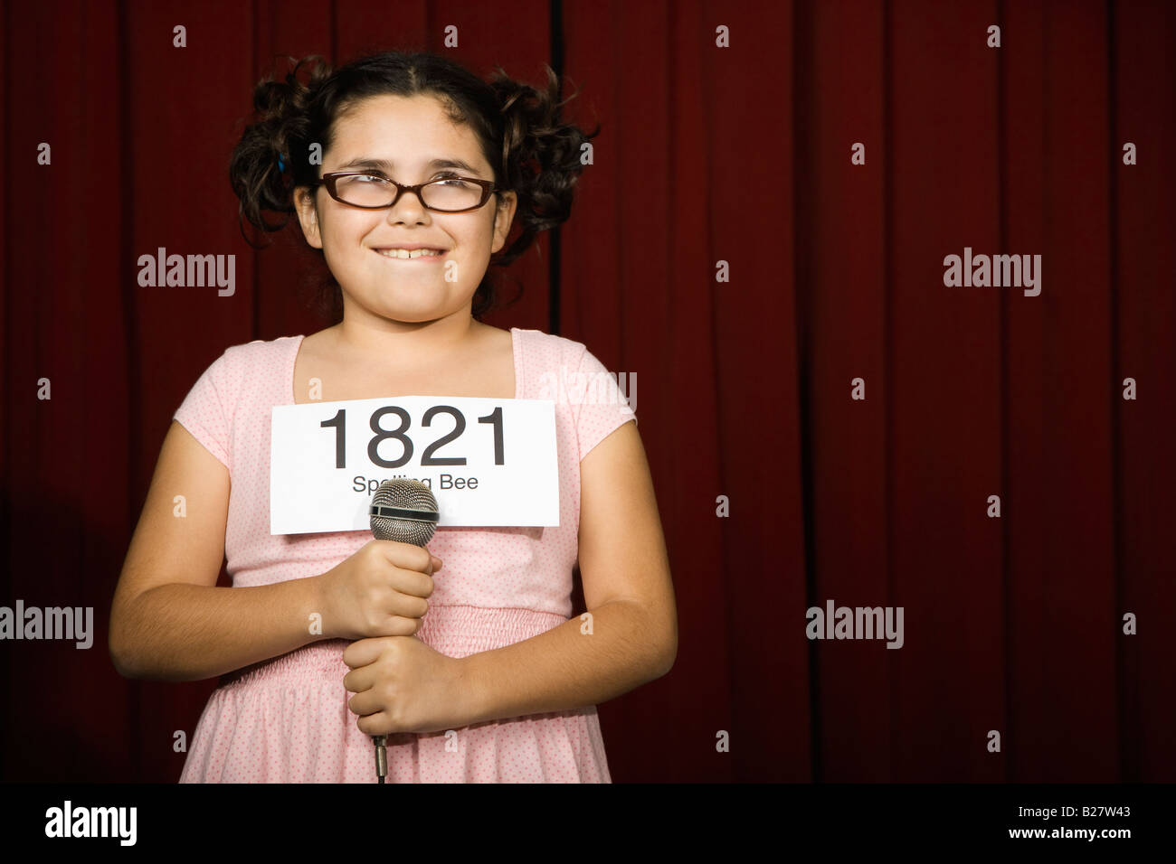 Girl wearing number on stage Stock Photo - Alamy