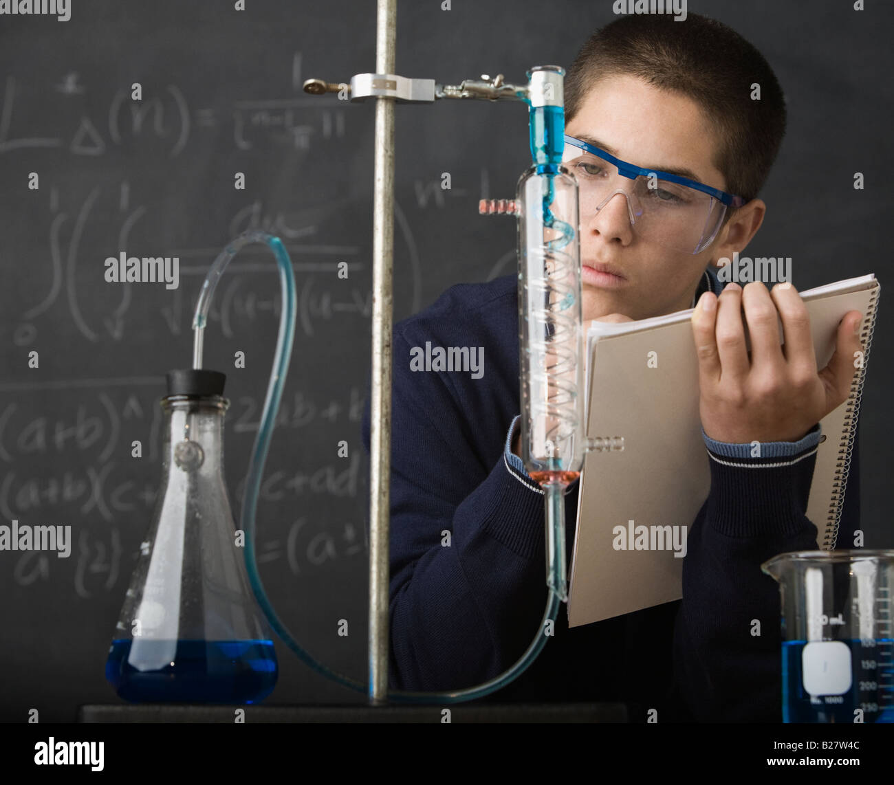Boy taking notes in science class Stock Photo - Alamy