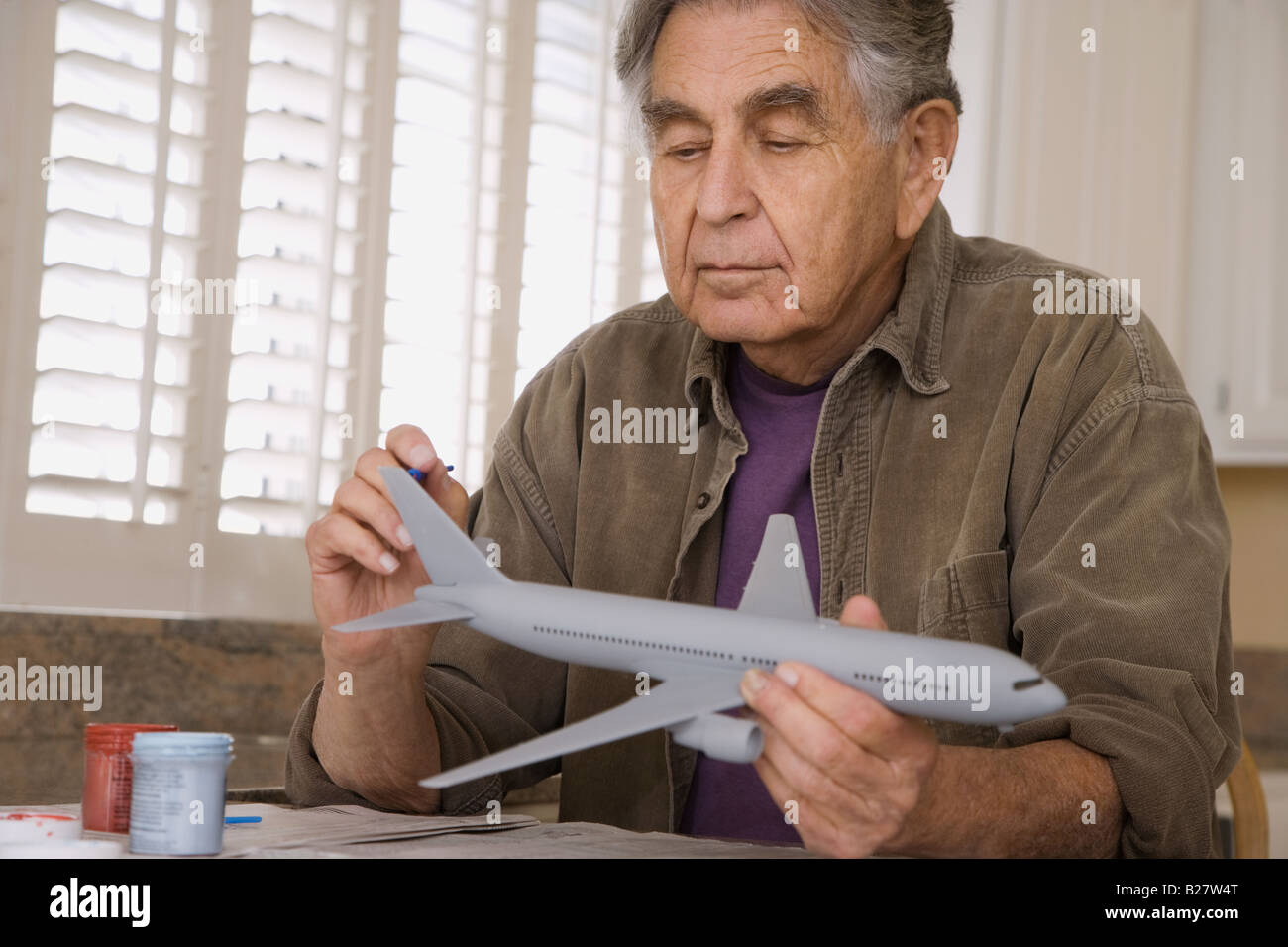 Senior man painting airplane model Stock Photo - Alamy