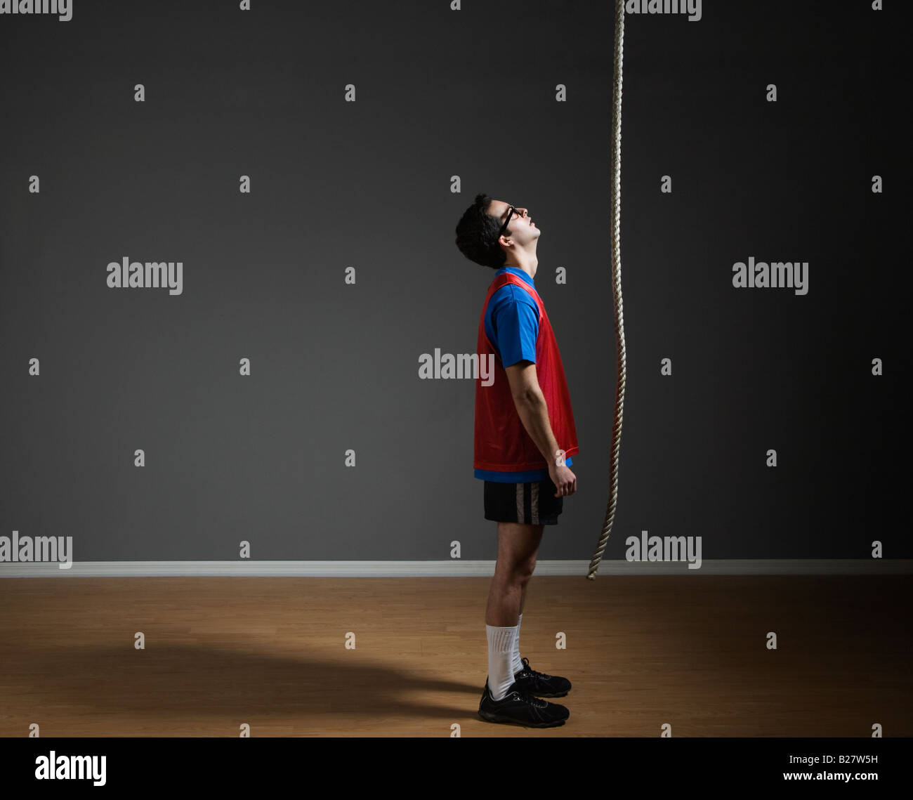 Man looking up at rope Stock Photo - Alamy