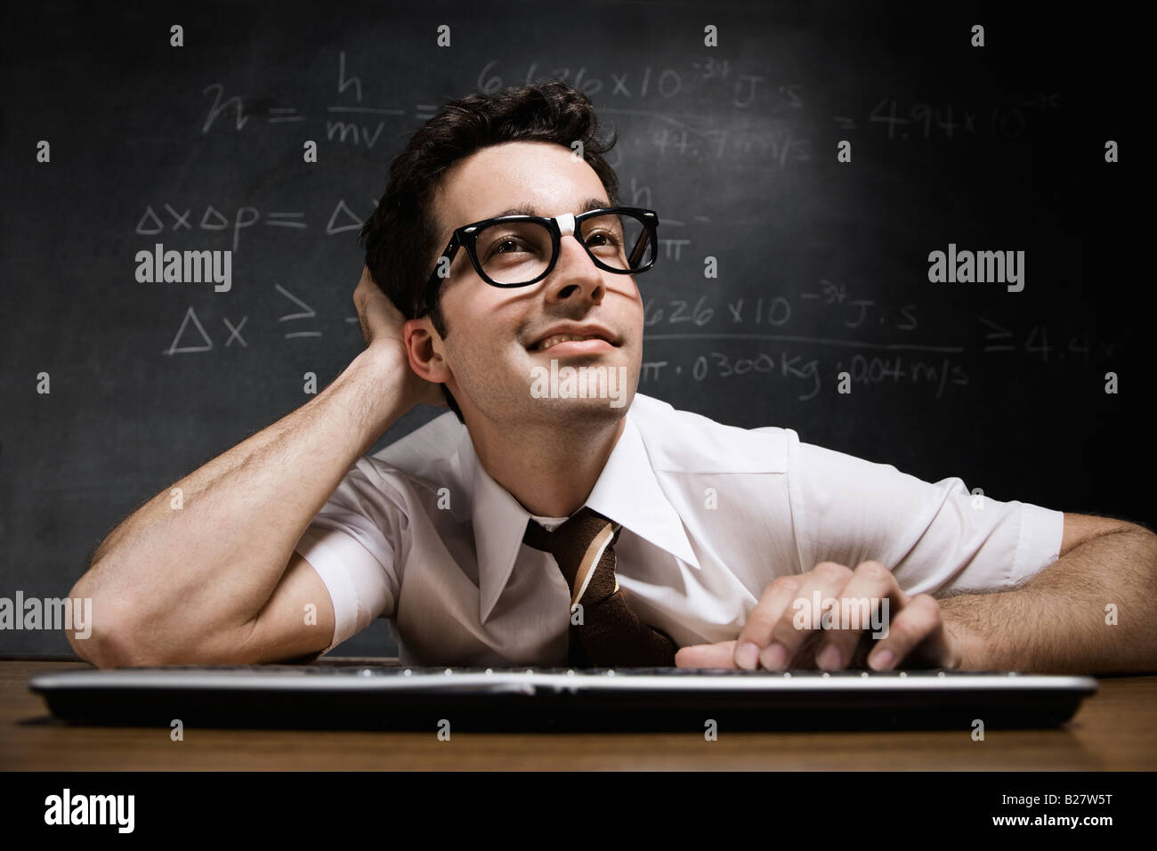 Nerdy man in front of blackboard Stock Photo - Alamy