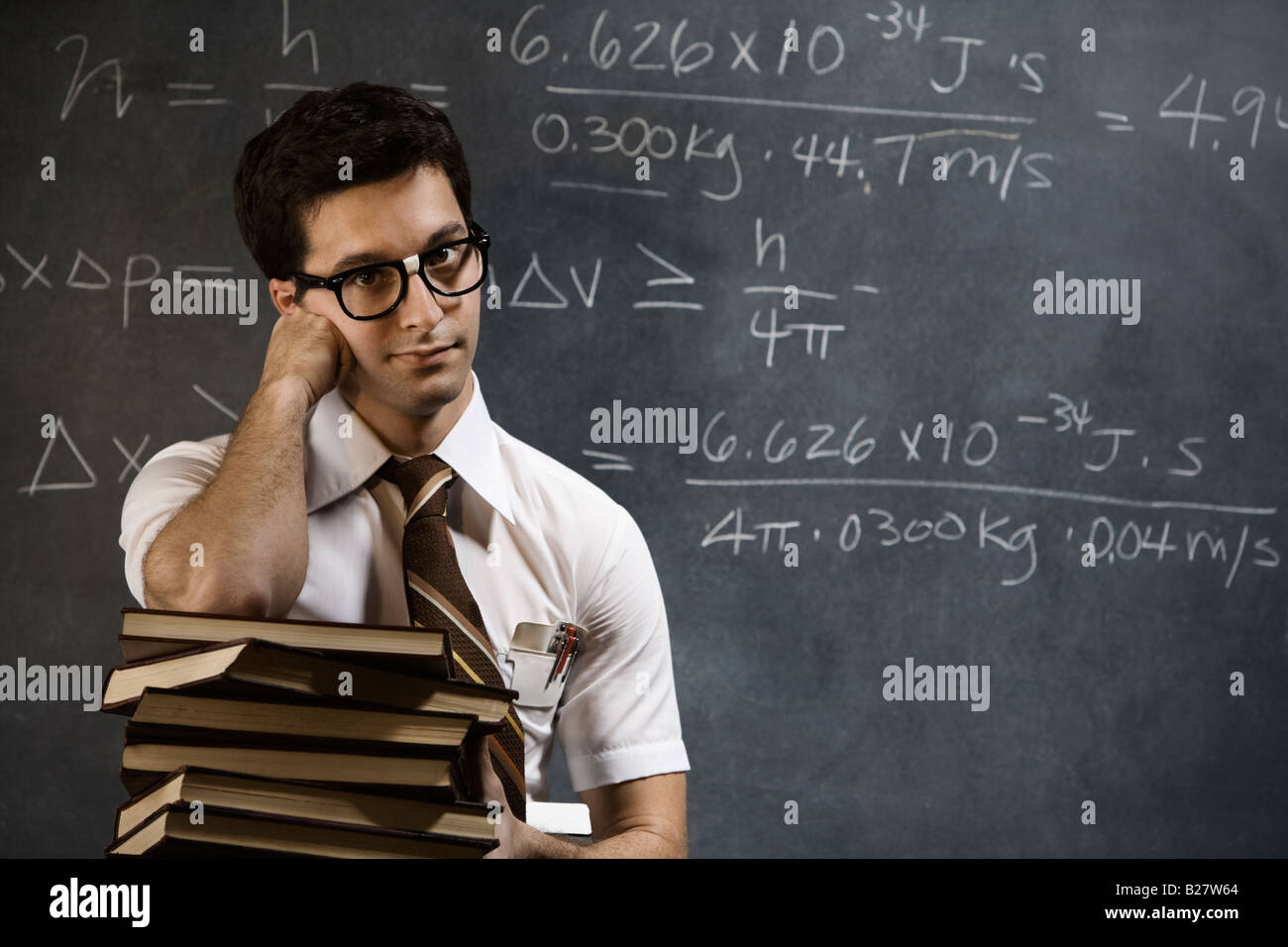 Nerdy man in front of blackboard Stock Photo - Alamy
