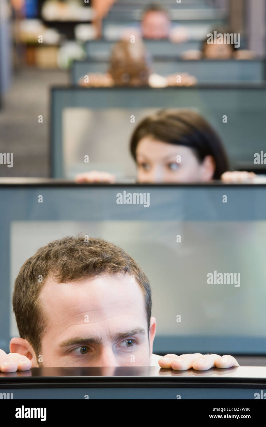 Businesspeople peeking over cubicle walls Stock Photo - Alamy